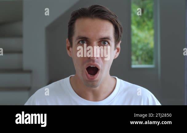 Portrait of surprised man looking at the camera and showing WOW emotion ...