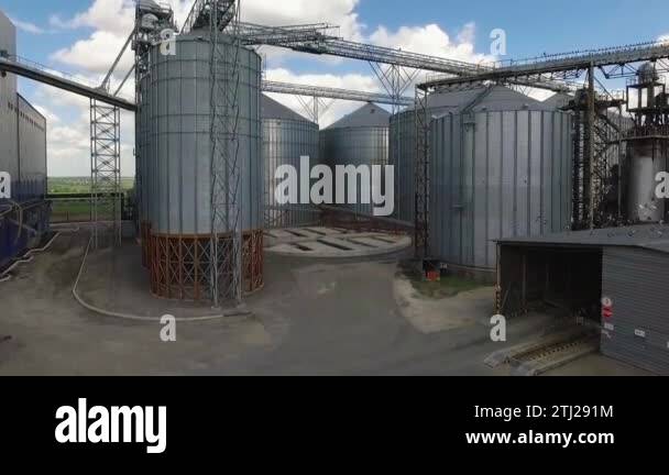 Storage facility for soy and wheat grains. Harvesting. Grain elevator aerial view. A tank for ...