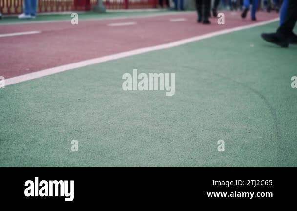 A red cycle path where people walk. Bicycle path for cycling. Feet ...