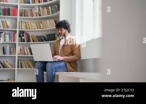 Young student using laptop computer to type for online e-learning in ...