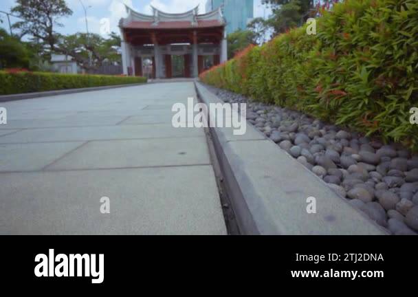 The great Chinese gate wind the grey wall and a red rooftop standing ...