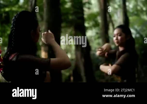 Two women fighting each other with traditional dancing moves in the ...