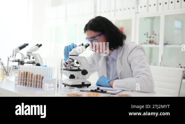 Excited man scientist makes important discovery looking in microscope ...