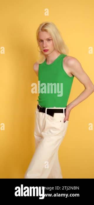 Androgyny. Transgender guy in a green top posing on background ...