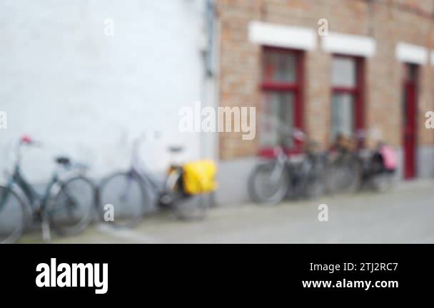 Out of focus background plate of city street with row of parked ...