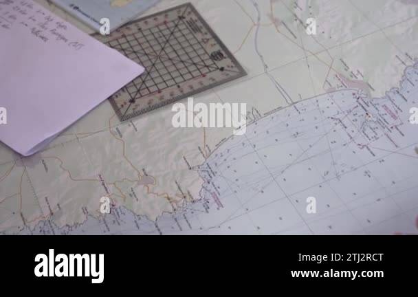 Close-up of the navigator's hand showing the route on the map with a ...