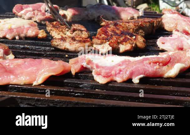 Fried meat is pierced with a fork. Meat juice and fat sizzle. The ...