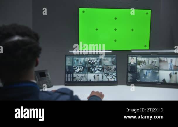 African American male officer controls CCTV cameras with AI face ...