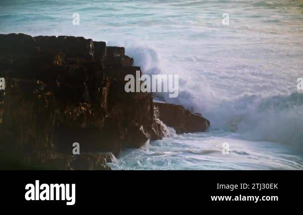 Dramatic sea breaking cliff on stormy day. Powerful waves crashing ...