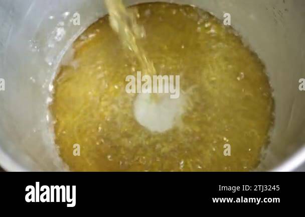 Steel container being filled with an extracted or purified liquid soap ...