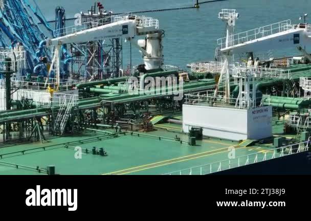 Petroleum Tanker Vessel Offloading Fuel and Oil at a Refinery Port ...