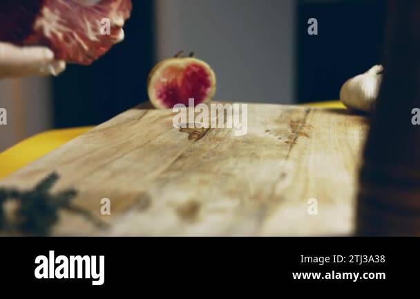 Chef cleans raw meat and cuts off connective tissue and surface ...
