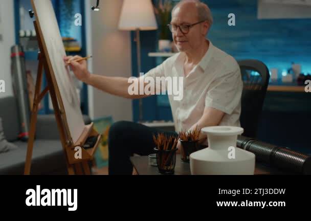 Senior artist drawing professional artwork with vase model, creating ...