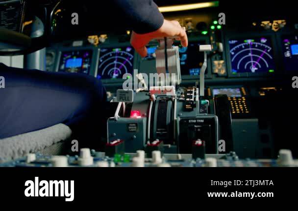 Close-up of a pilot's hand pressing the throttle in the cockpit of jet ...