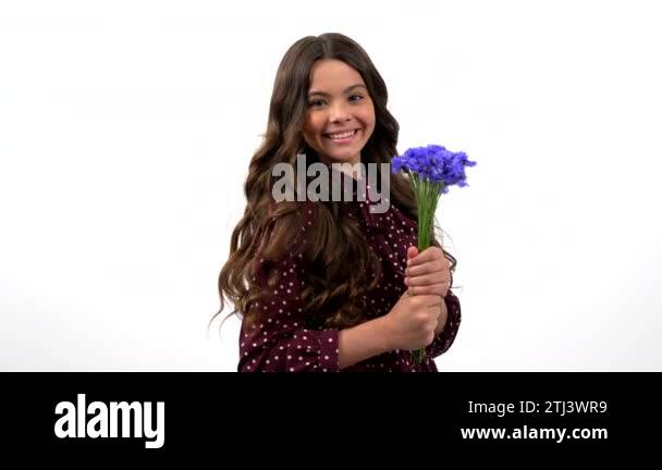 happy beautiful child long curly hair turning wildflower flower bouquet of centaurea show peace ...