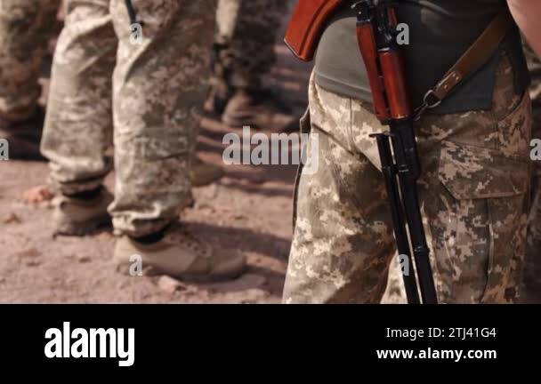 A row of Ukrainian soldiers line up at the checkpoint, wearing military ...