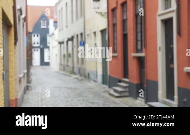 Out of focus background plate of narrow cobblestone street in Europe ...