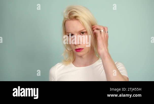 Androgyny. Transgender guy with makeup posing on background. Masculine ...