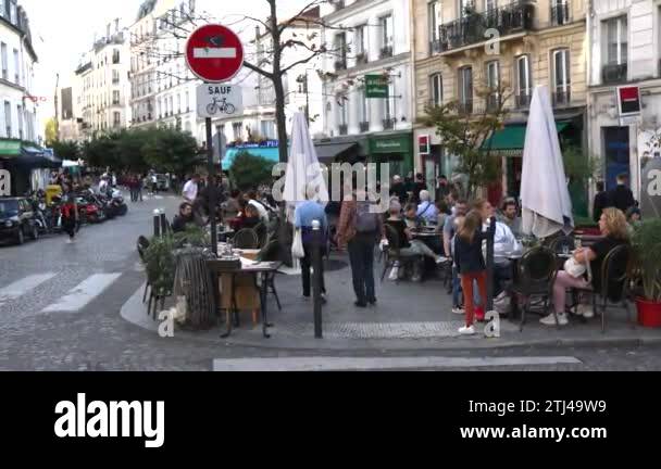 Typical French street in the Montmartre district with cafes ...
