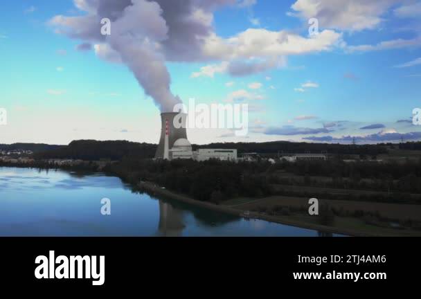 Flying along nuclear power plant and river. Nuclear power station with ...