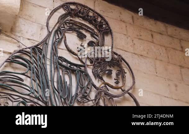 Bending wire into beautiful shapes of Virgin Mary and Jesus Christ in ...