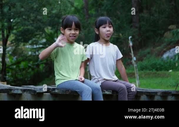 Two little sisters quarreling and crying while sitting together on a ...