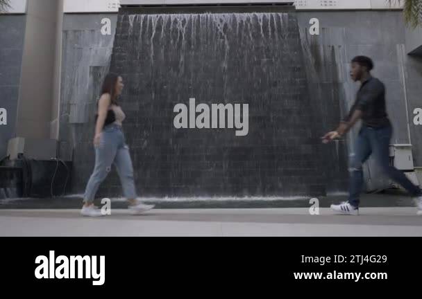 Joyful interracial couple give goofy hug. Boy lifts the girl off the ...