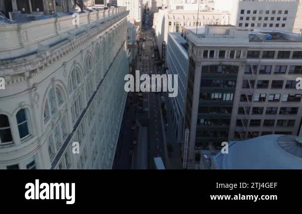 Fly along historic Phelan Building on roof level. Cars driving in ...