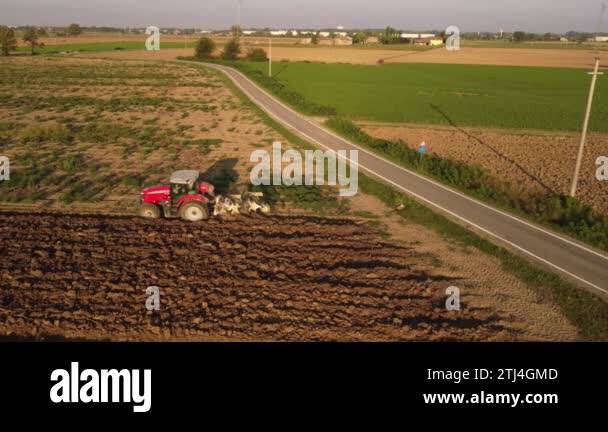 4k video red tractor plowing Stock Videos & Footage - HD and 4K Video ...