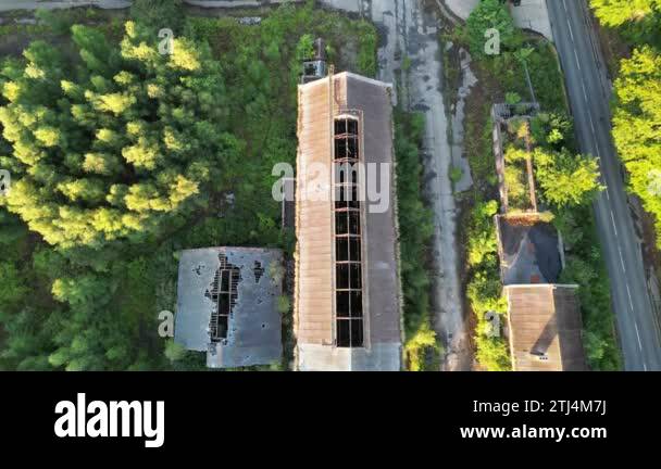 Birds-eye-view directly into a derelict, overgrown, coal mining ...