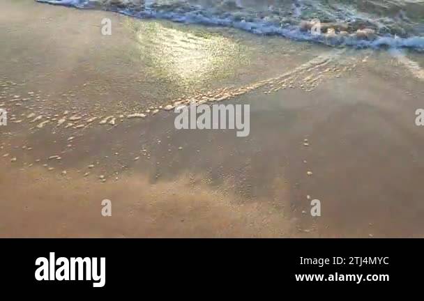 Sea waves rolling on sandy shore beach on sea coast at dawn sunset ...