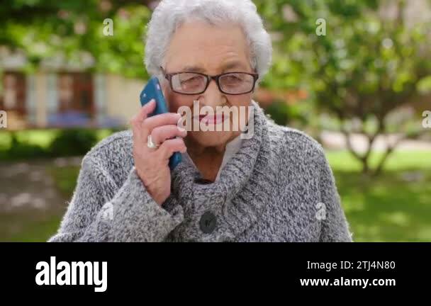 Phone call, retirement and senior woman at park talking, speaking or ...