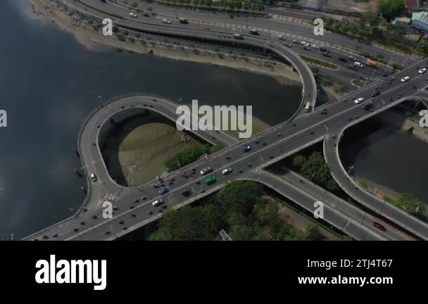 Aerial panning shot above complex road system connecting bridges on and ...