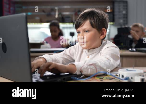 Portrait of focused smart caucasian school boy programming software for ...