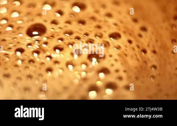 Bubbles with froth on surface of hot cocoa being stirred close-up Stock ...