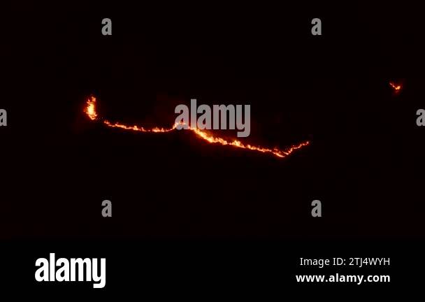 Night fire in the forest with fire and smoke.Epic aerial video of a ...