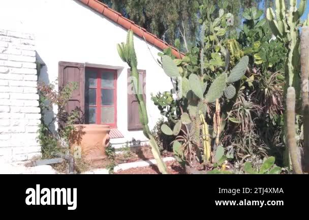 White wall of mexican old village house, wooden window with shutters ...