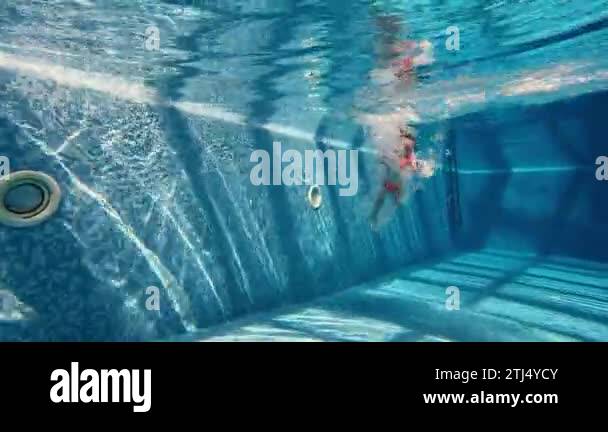 Cute little baby girl, toddler in pink swimsuit diving, swimming ...