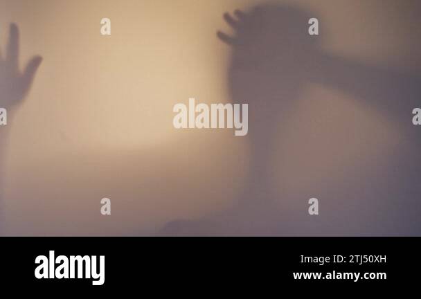 Shadow Blur of a horror man behind frosted glass. Blurred hand, body ...