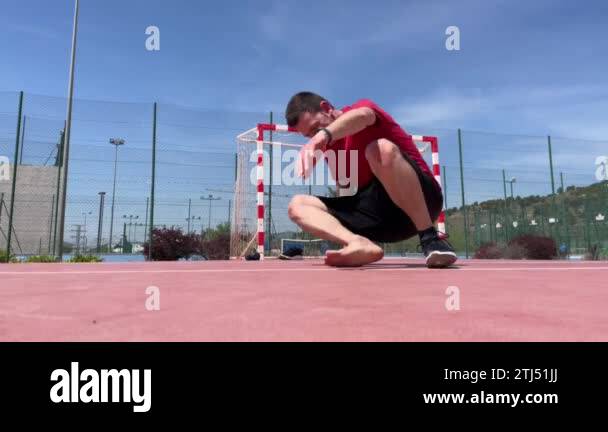 Twisted ankle. Futsal injury. Male falls down and touches foot in pain ...