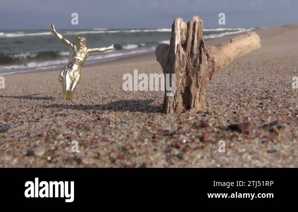 Crucified Jesus Christ without a cross and a log on the beach Stock ...