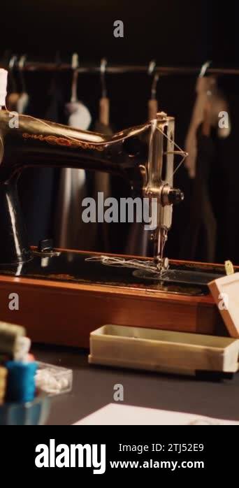 Vertical video Old school sewing machine in atelier, fashion industry ...