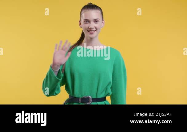 Friendly teenage girl waving hand - hello. Greeting, say Hi to camera ...
