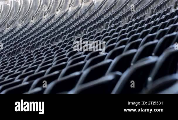 Rows of seats in football stadium in 4K - Rack focus of many seats ...
