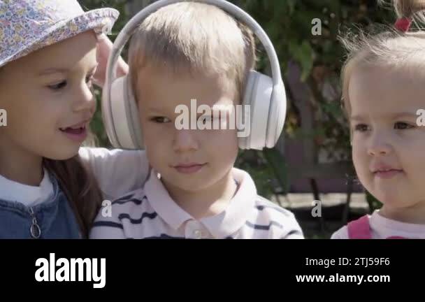Portrait of Cute Little Three Children With Headphones Listening to ...