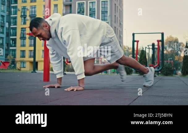Healthy latino american sportsman jogger performing running plank ...
