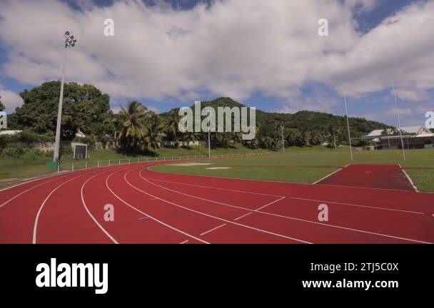 Running track, red racing tread in football stadium in Caribbean Cook ...