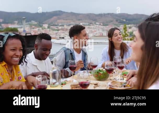 Hipster group of young friends eating and drinking at home terrace ...