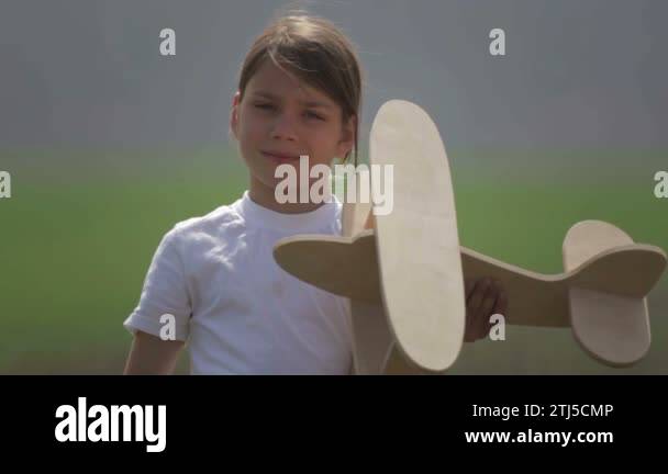 Caucasian boy playing with a model airplane. Portrait of a child with a ...