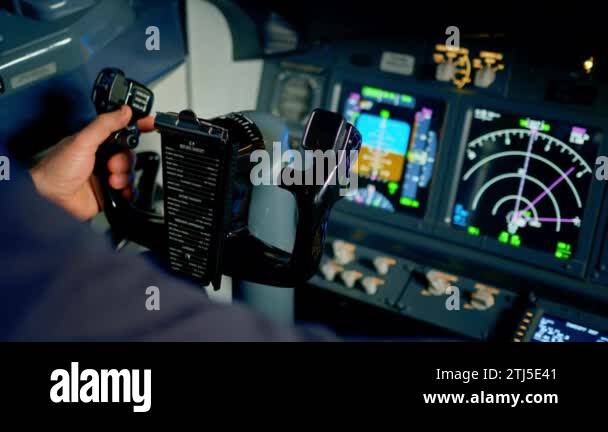 Pilot in airplane cockpit holding turning wheel rudder during flight ...